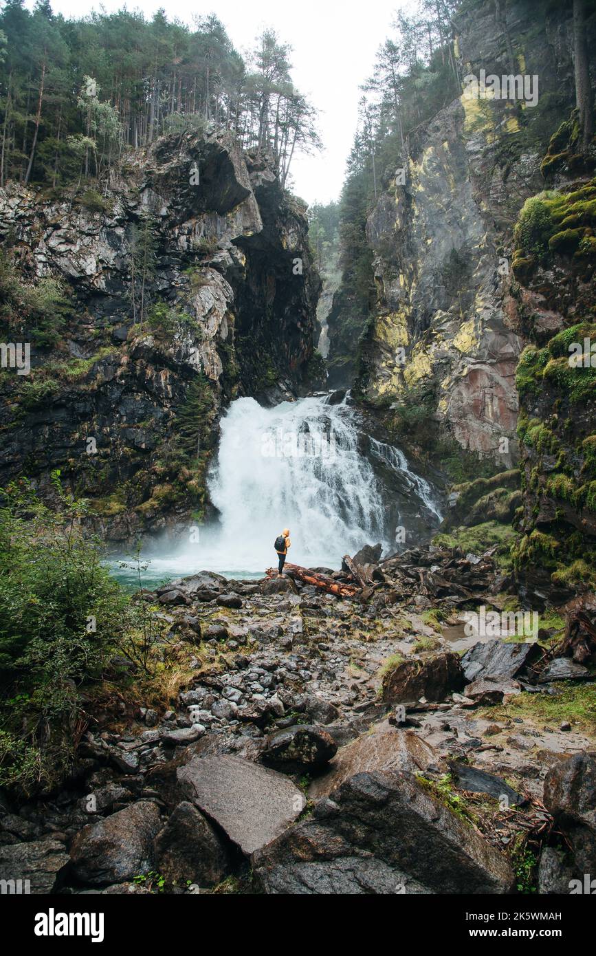 landscape photo of Riva waterfall at Dolomites with a brave hiker ...