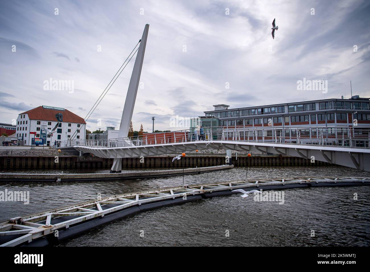 Bremen, Germany. 10th Oct, 2022. Passers-by walk across a bridge at the ...