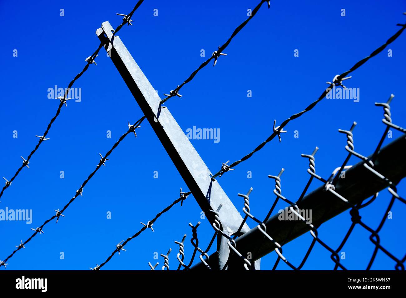Barbed wire fence for security and safety with extended metal arms ...