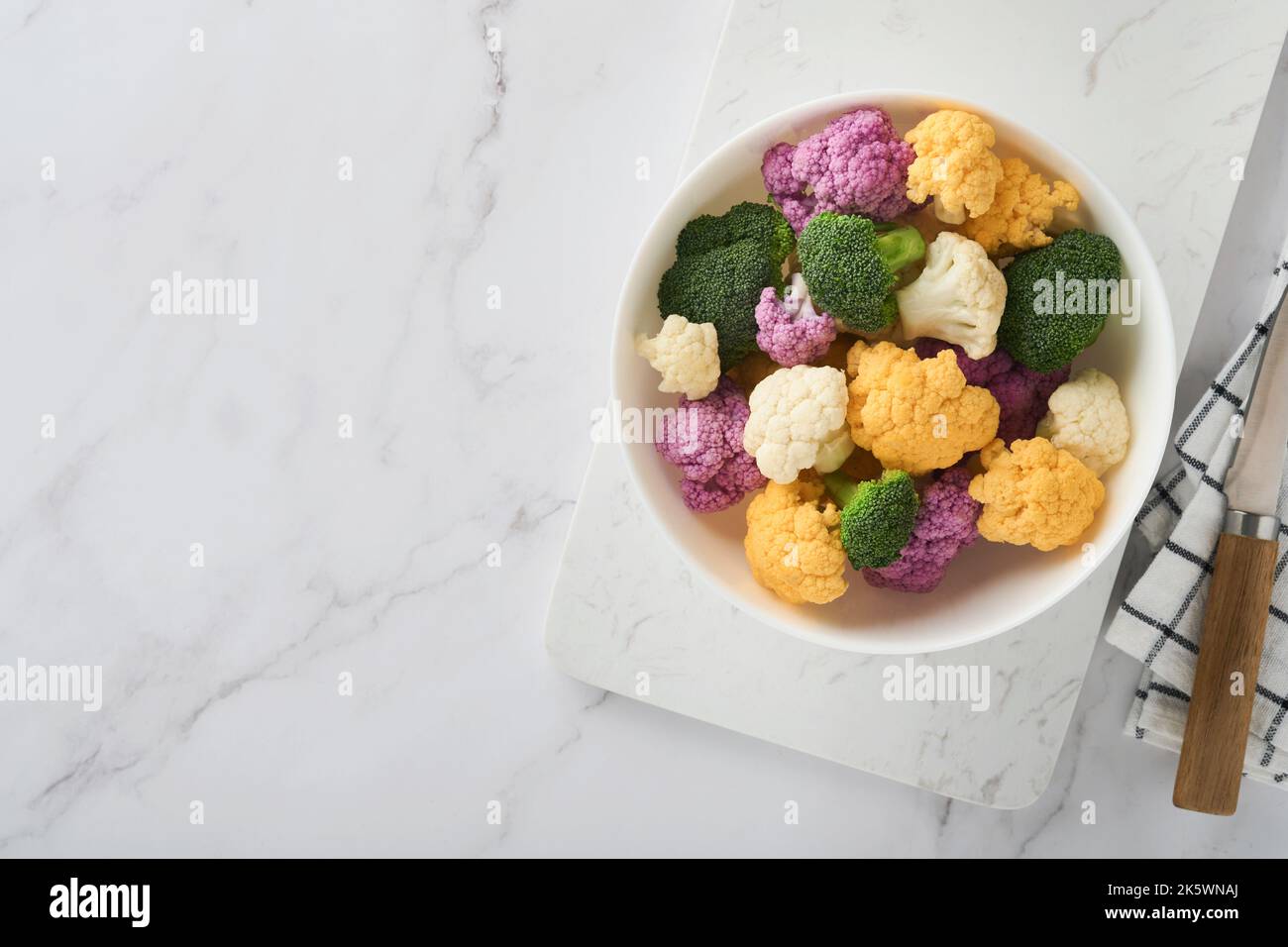 Colorfu cauliflower. Cauliflower cut into small pieces white bowl on ...