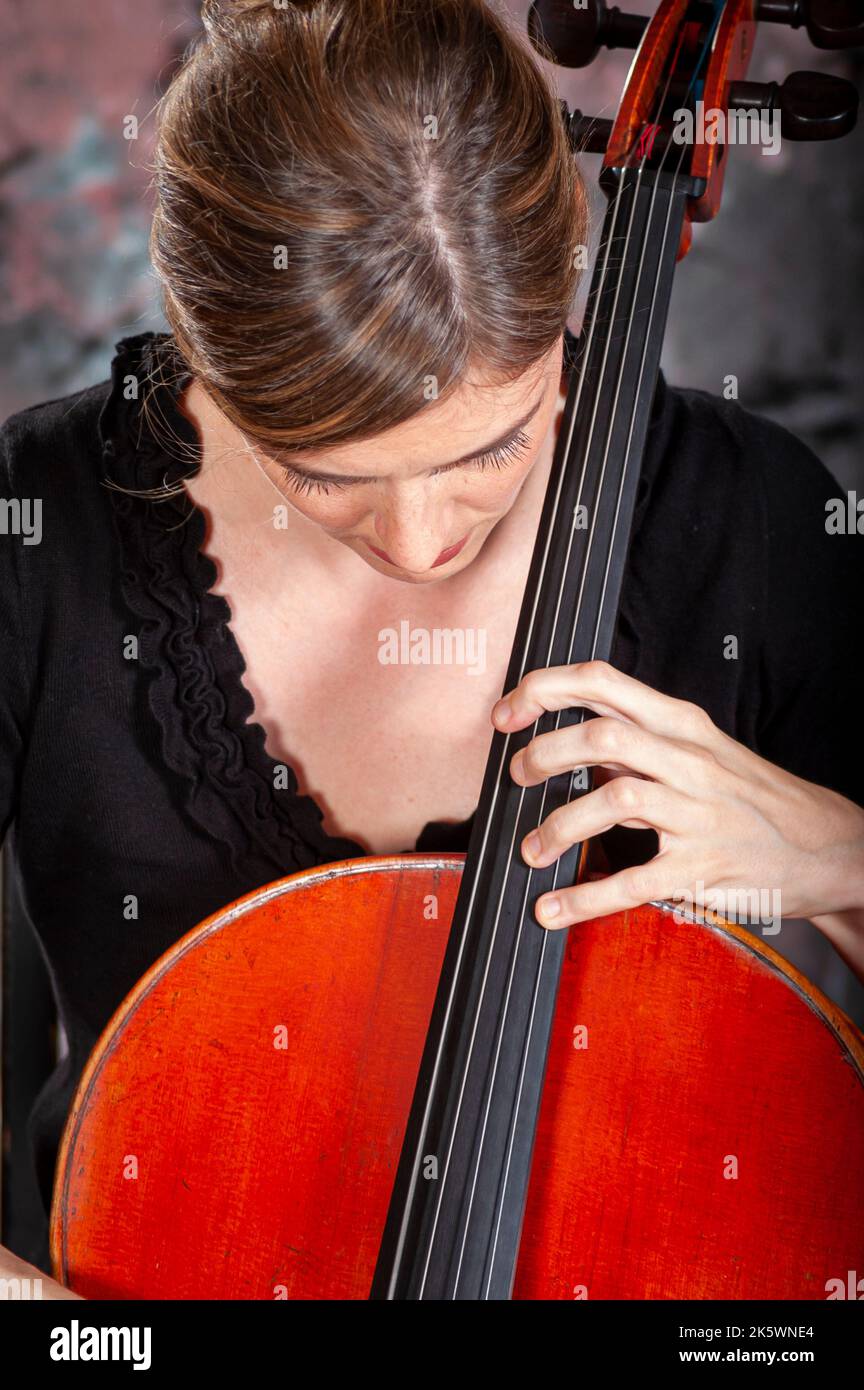Young female cellist, Cello player in playing position Stock Photo - Alamy