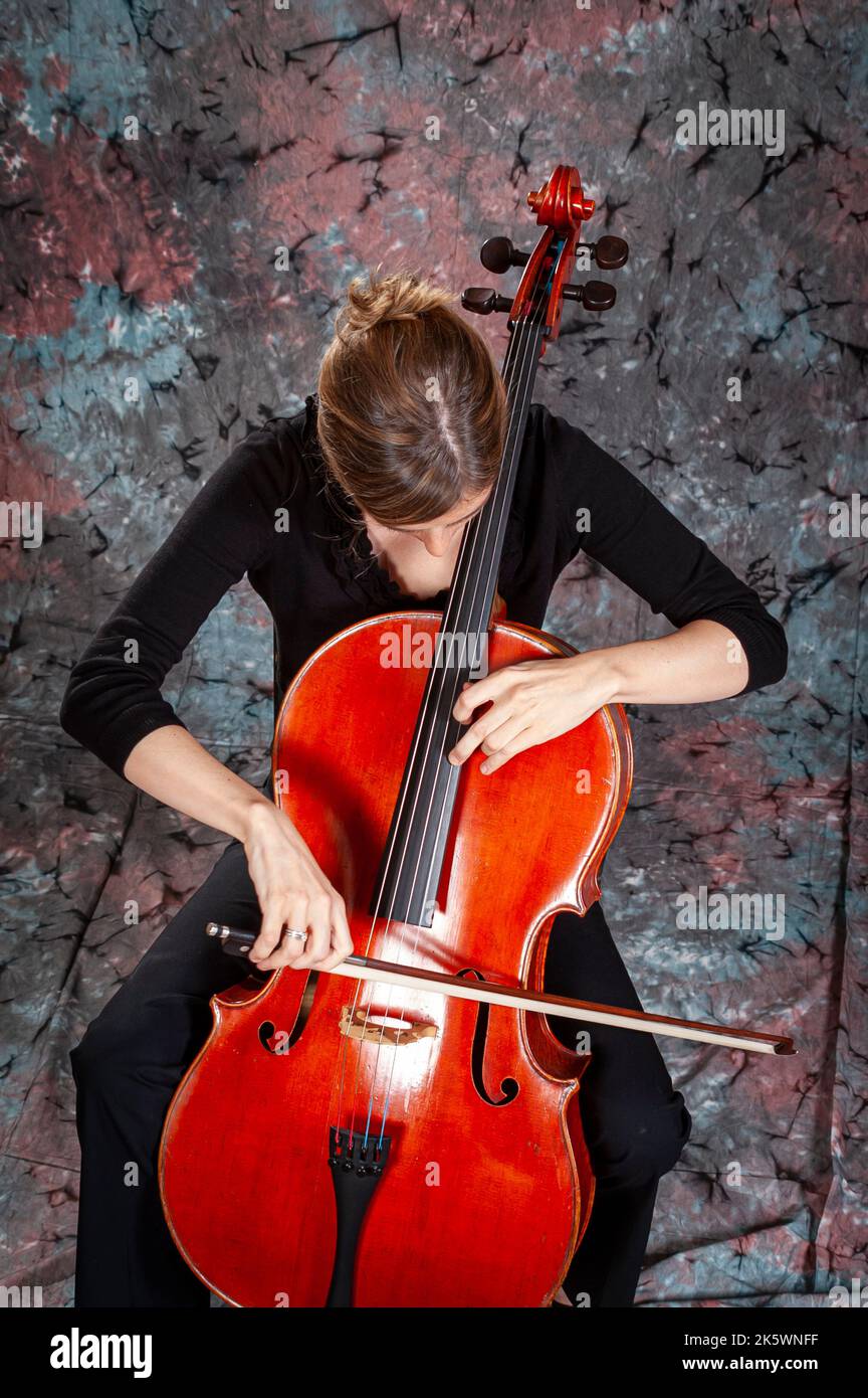 Young female cellist, Cello player in playing position Stock Photo - Alamy