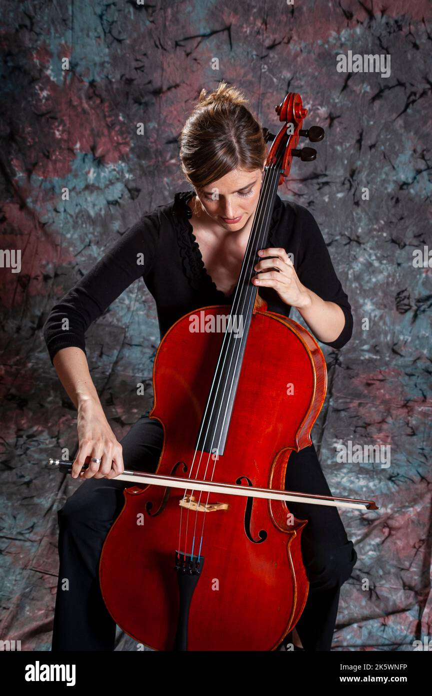 Young female cellist, Cello player in playing position Stock Photo - Alamy