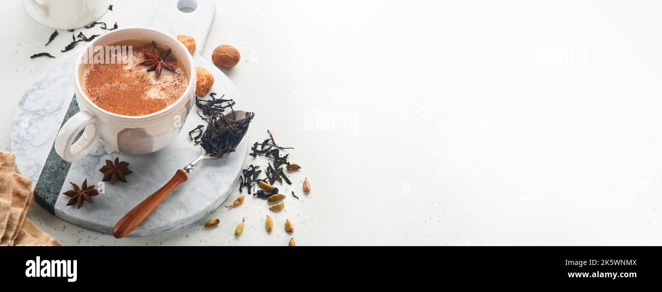 Masala tea. Masala chai spiced tea with milk and spices on light grey ...