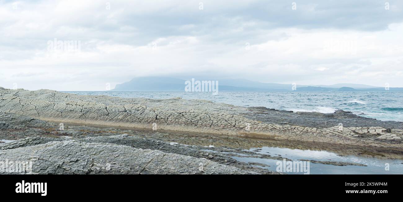 rocky seashore made of columnar granite, hardened lava, resembling ...
