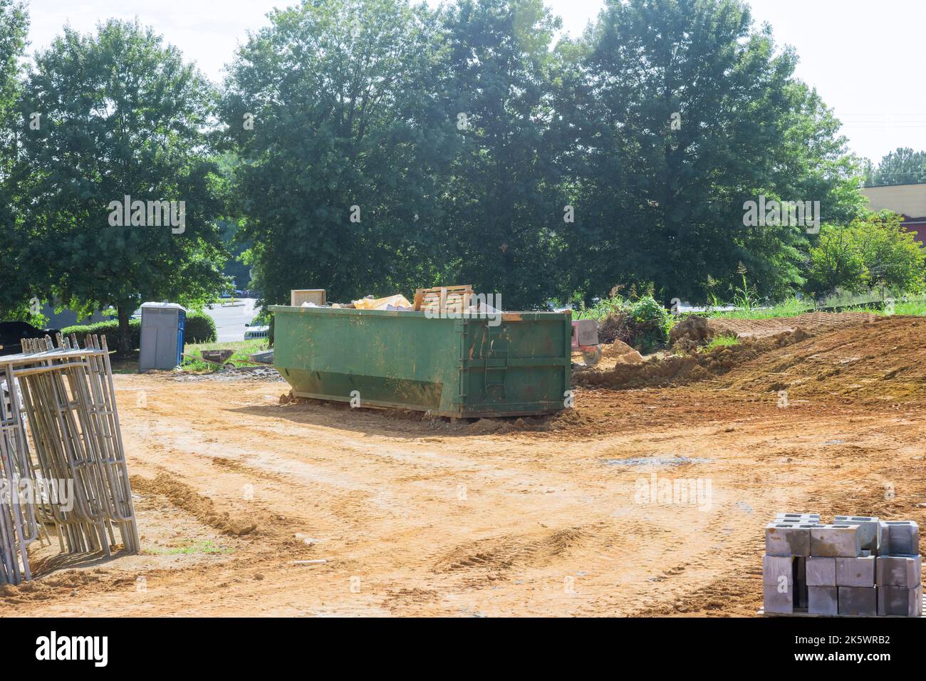 Home renovation maintenance a loaded dumpster near a construction site ...