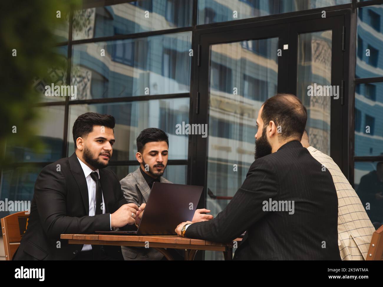 Business partners standing meeting table hi-res stock photography and ...