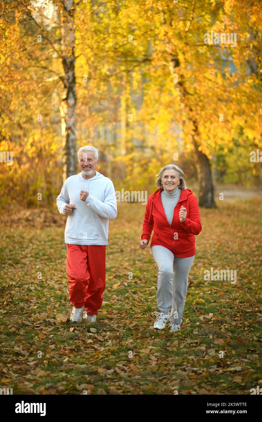 Elderly couple doing sports in the park Stock Photo - Alamy