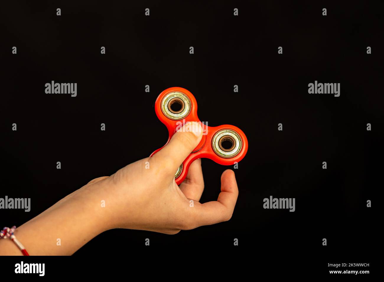 Child playing with a spinning fidget toy Stock Photo - Alamy