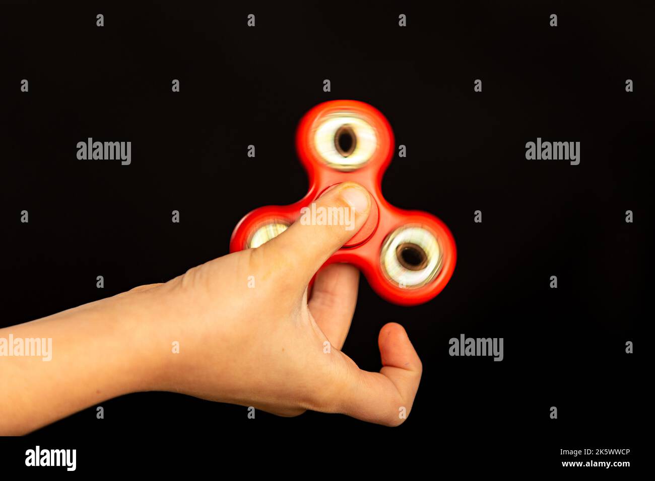 Child playing with a spinning fidget toy Stock Photo - Alamy