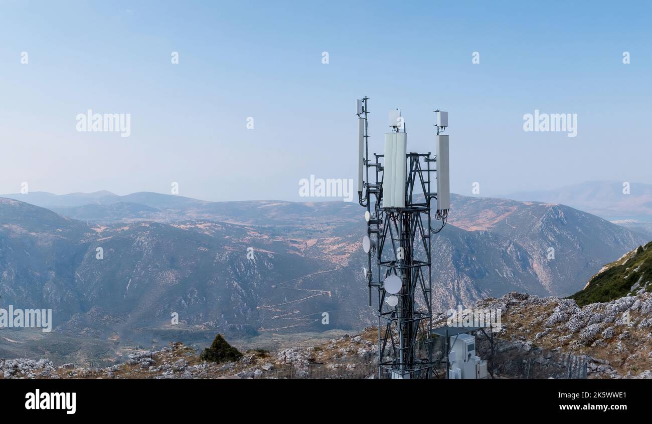 Cell phone tower. Cellular antenna, 5G radio network telecom transmitter aerial view. Rocky ...