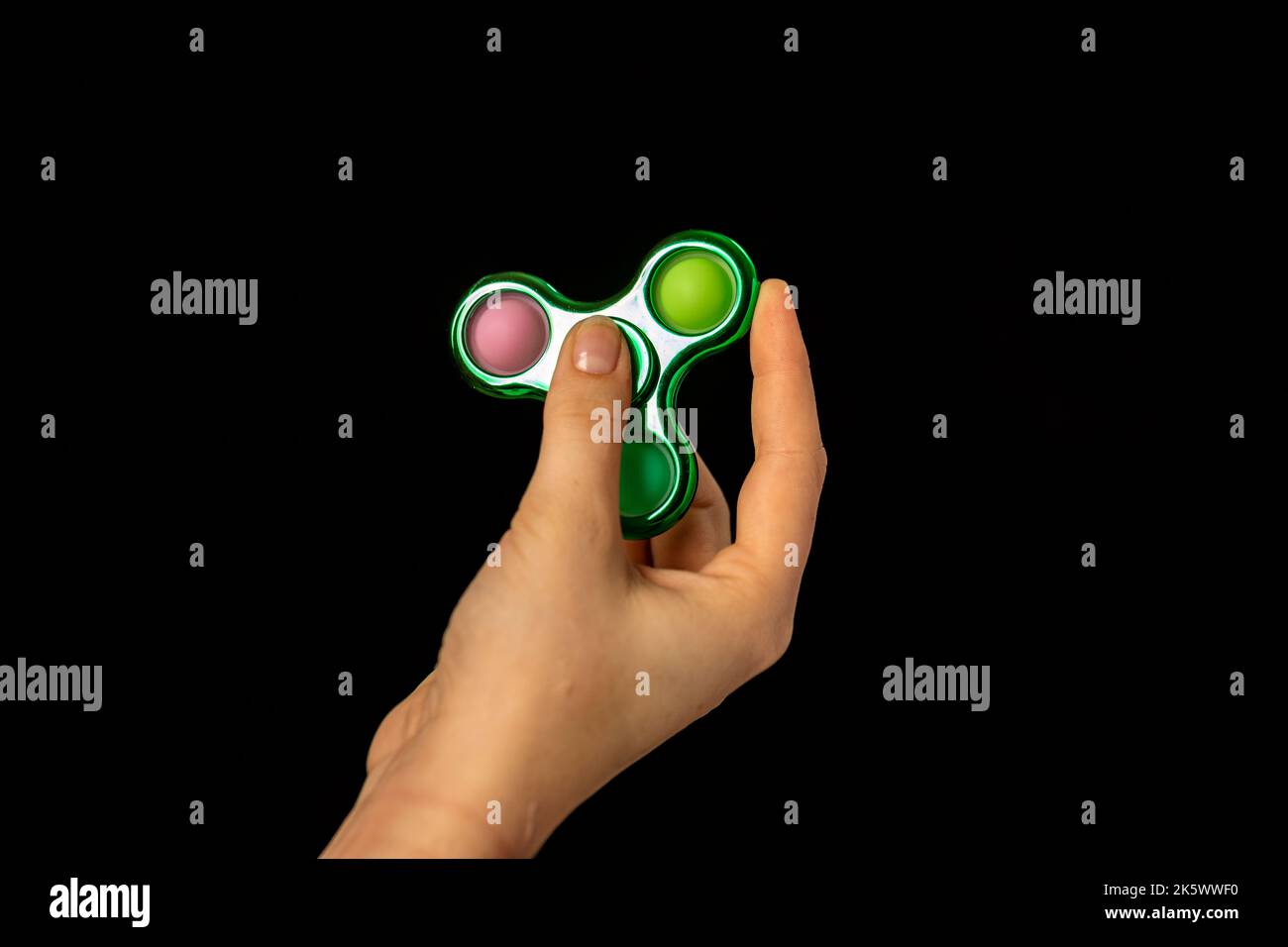 Child playing with a spinning fidget toy Stock Photo - Alamy