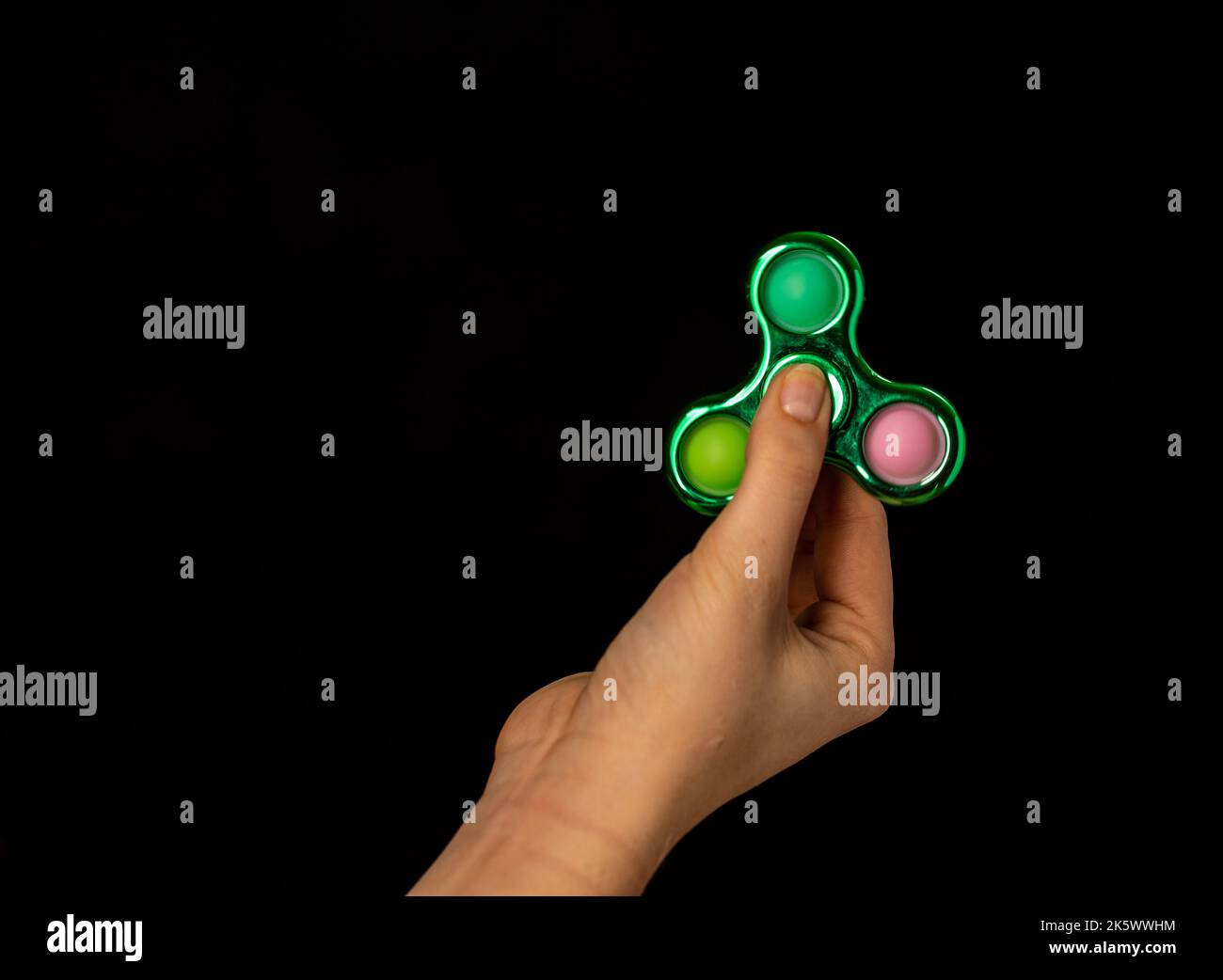 Child playing with a spinning fidget toy Stock Photo - Alamy