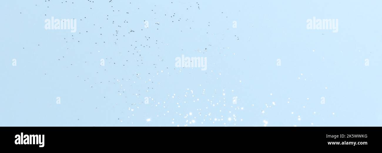 Sparkling silver glitter on blue background banner texture. Abstract ...