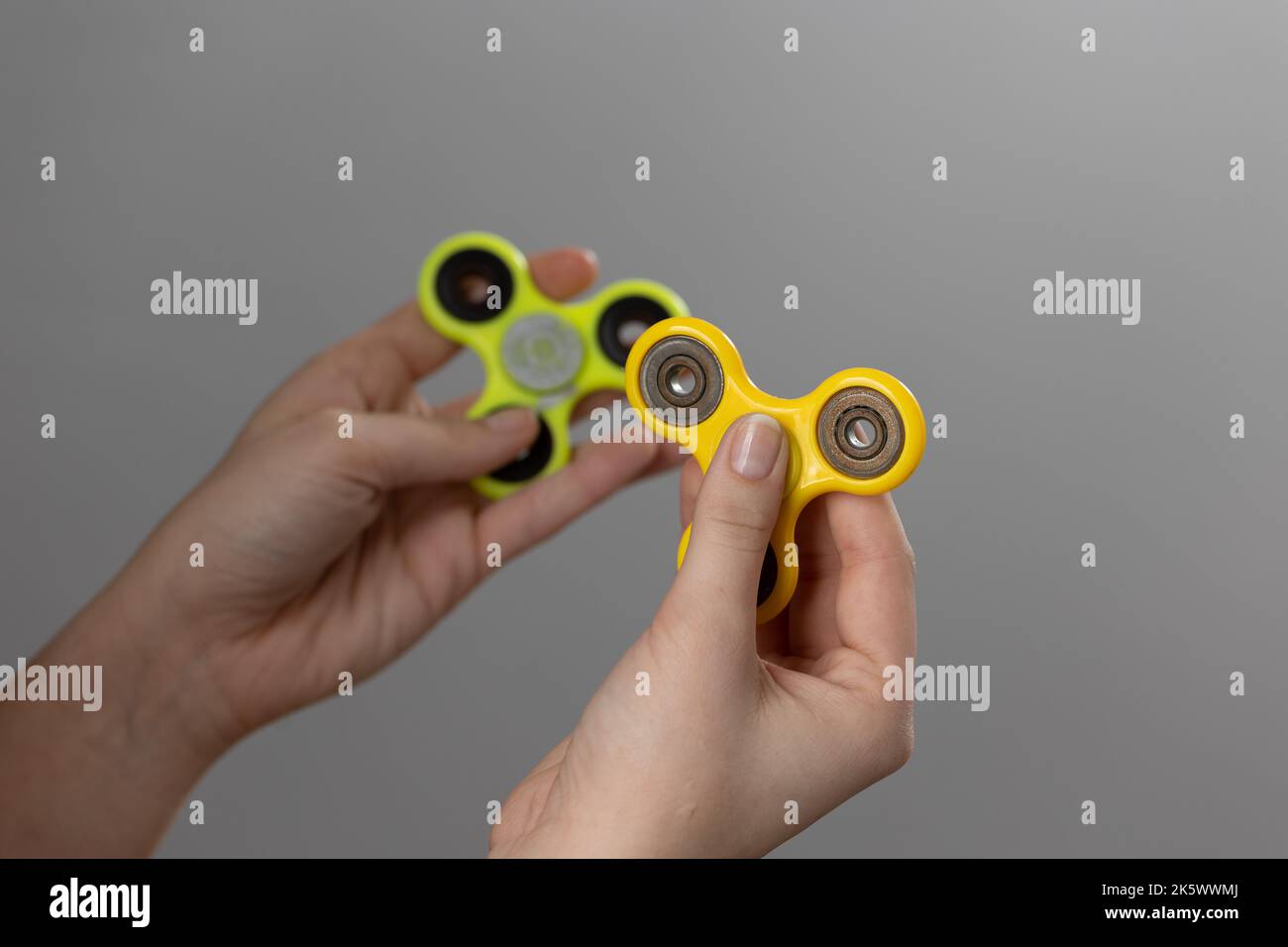Child playing with a spinning fidget toy Stock Photo - Alamy