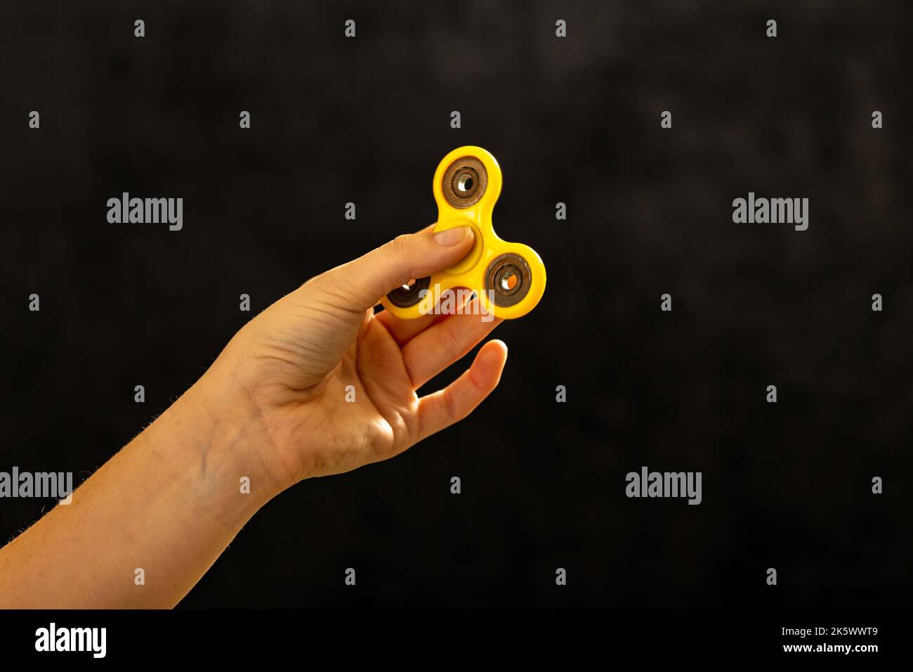 Child playing with a spinning fidget toy Stock Photo - Alamy