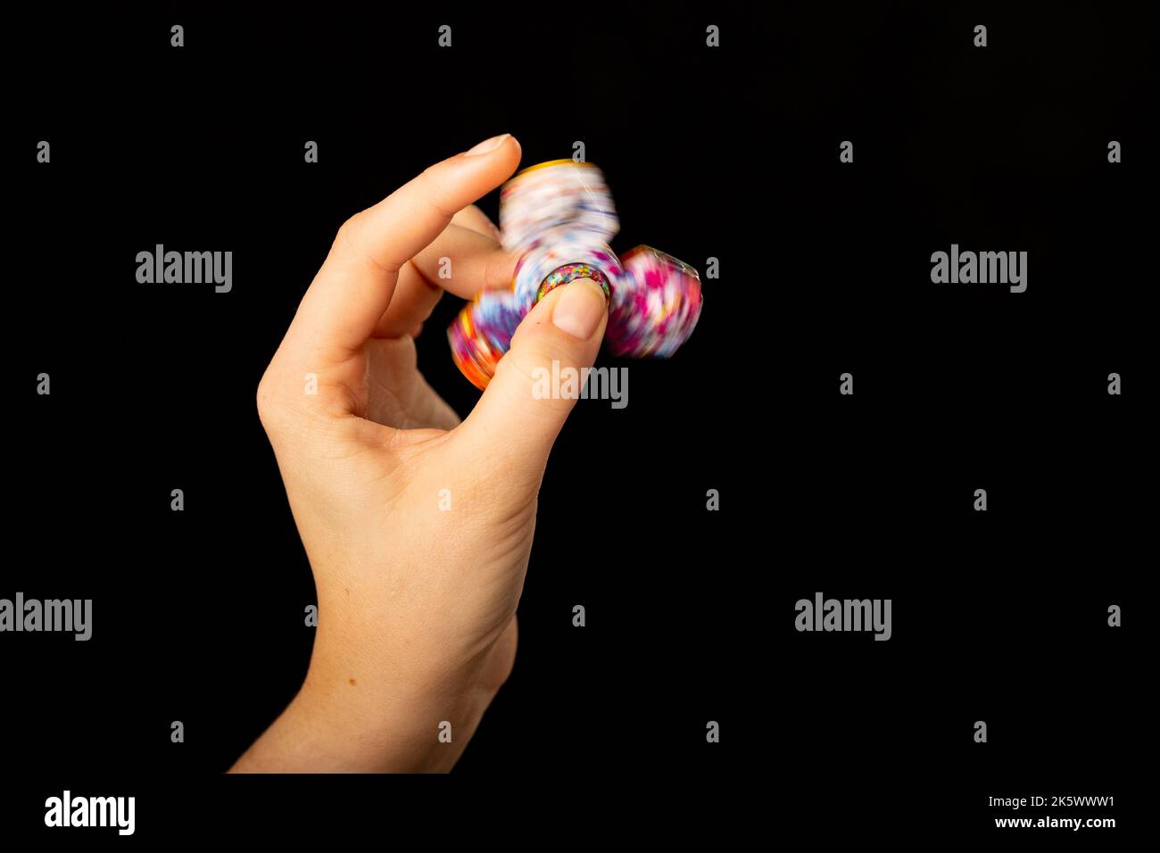 Child playing with a spinning fidget toy Stock Photo - Alamy