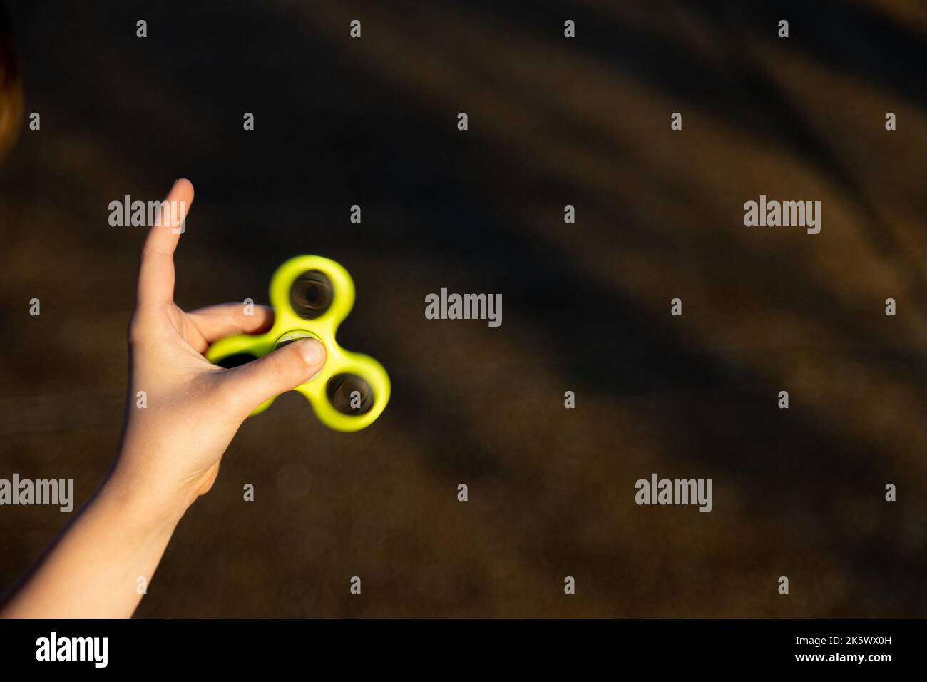 Child playing with a spinning fidget toy Stock Photo - Alamy