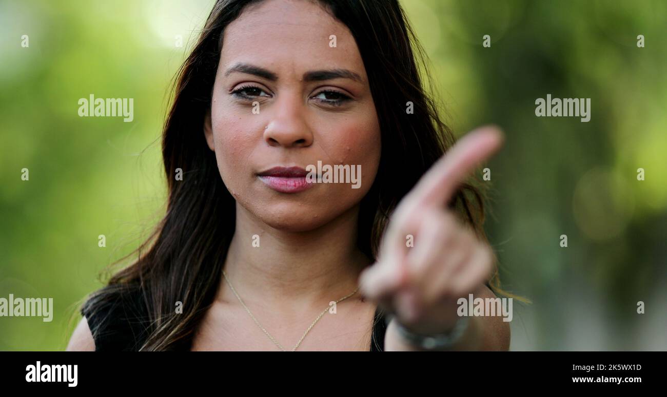 Woman annoyed making stop sign with hand, saying no, expressing defense ...
