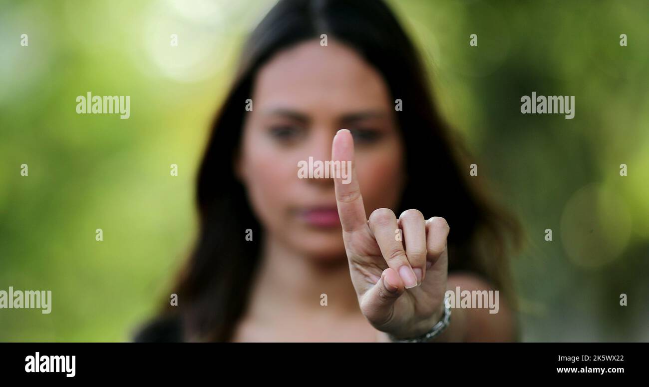 Woman annoyed making stop sign with hand, saying no, expressing defense ...
