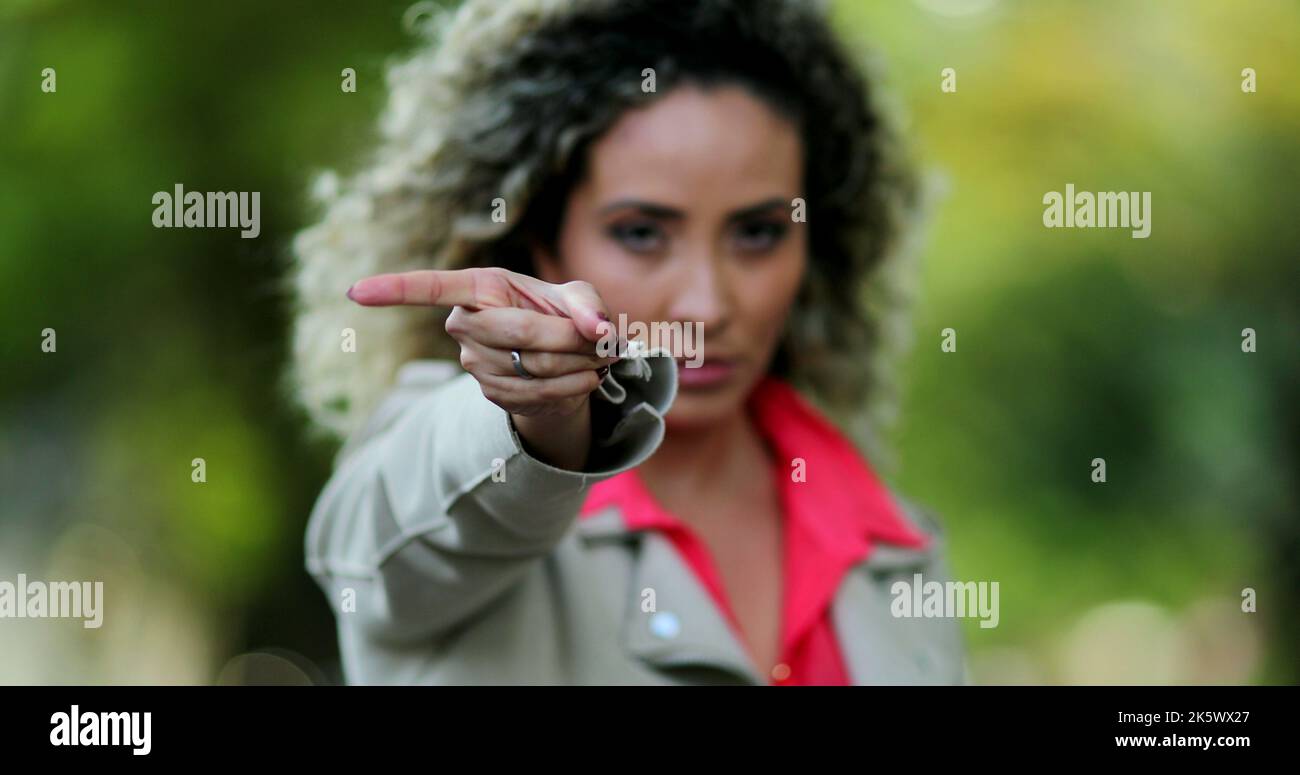 Woman annoyed making stop sign with hand, saying no, expressing defense ...