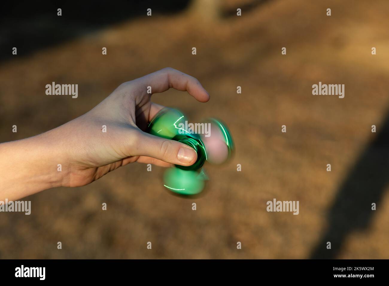 Child playing with a spinning fidget toy Stock Photo - Alamy