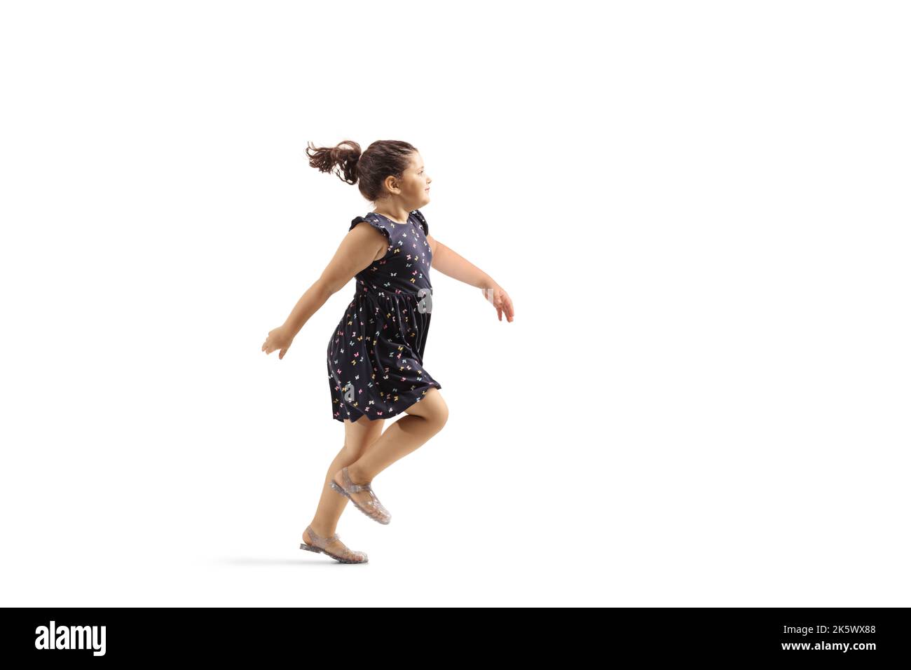 Full length shot of a little girl hopping isolated on white background ...