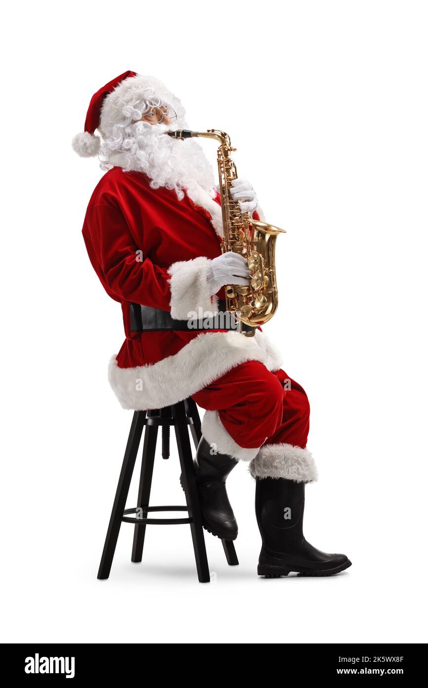 Santa claus sitting on a chair and playing a saxophone isolated on ...