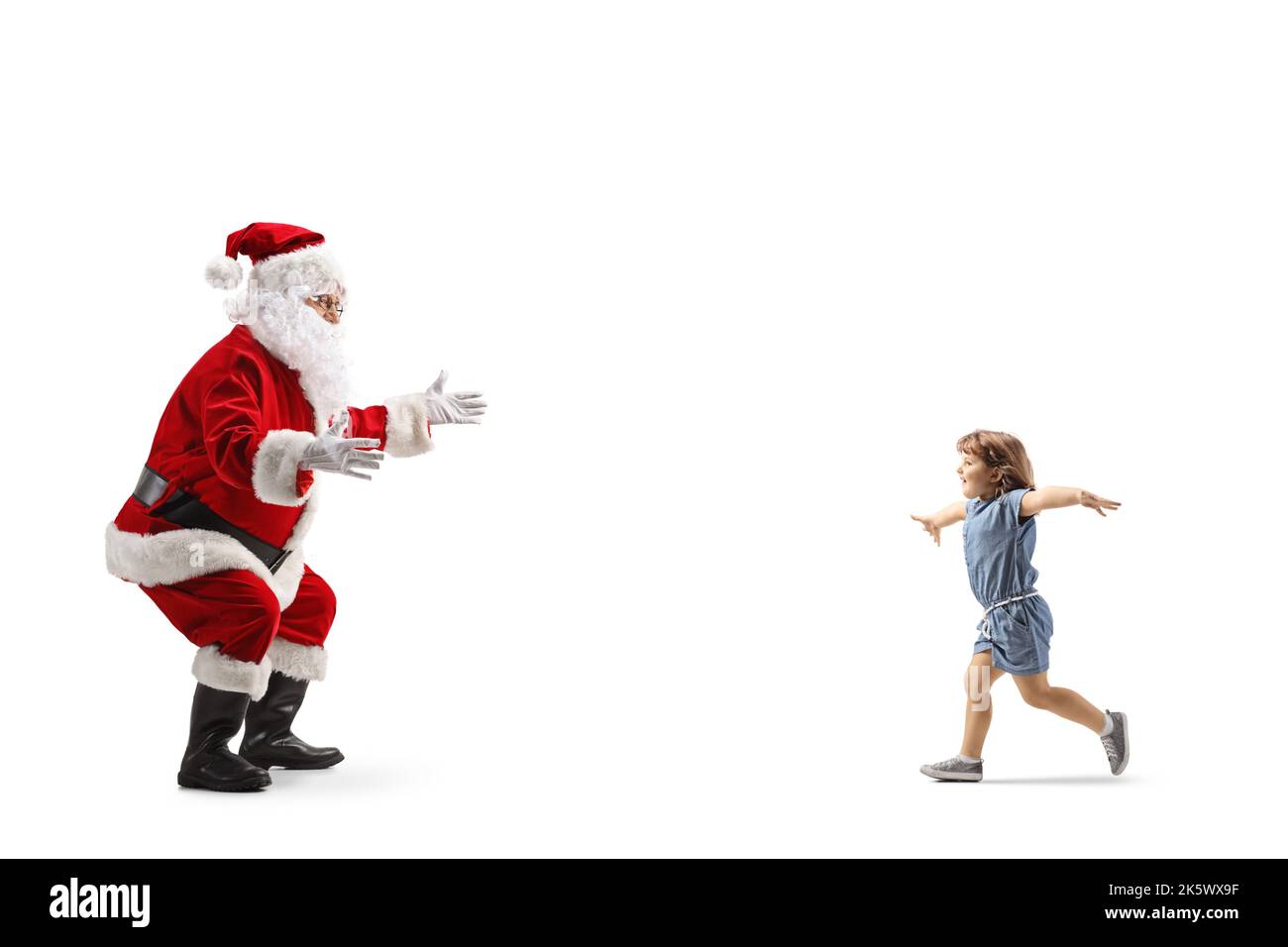 Happy little girl running to hug santa claus isolated on white ...