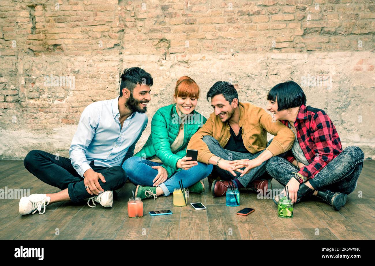 Group of hipster best friends with smartphones in grungy alternative ...