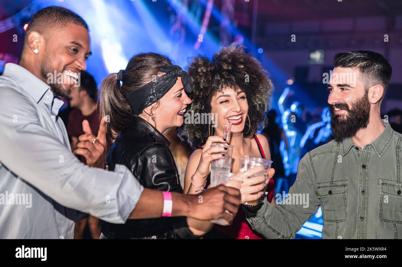 Multiracial young friends dancing at night club - Happy people having ...