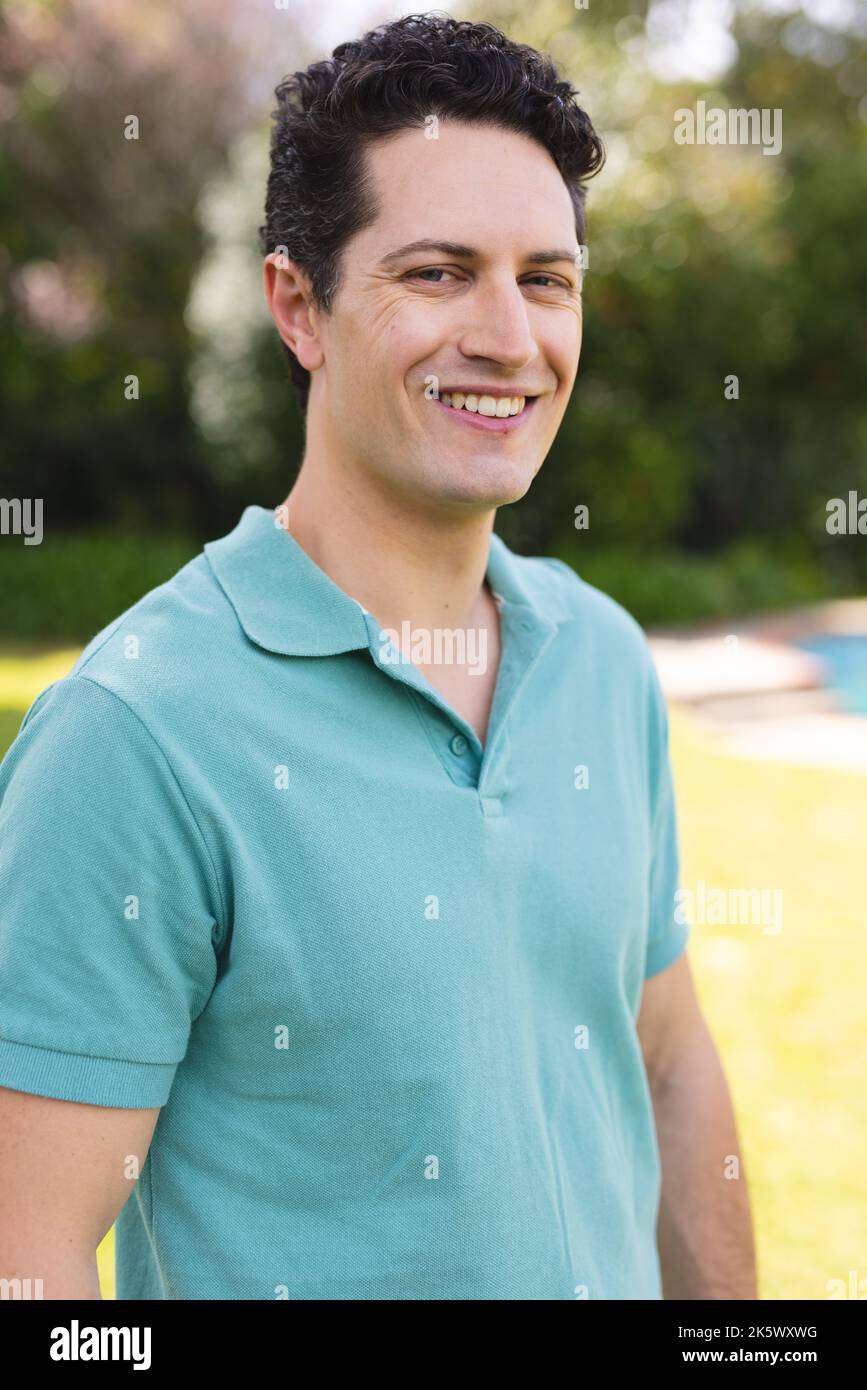 Vertical portrait of young caucasian men wearing blue shirt and ...