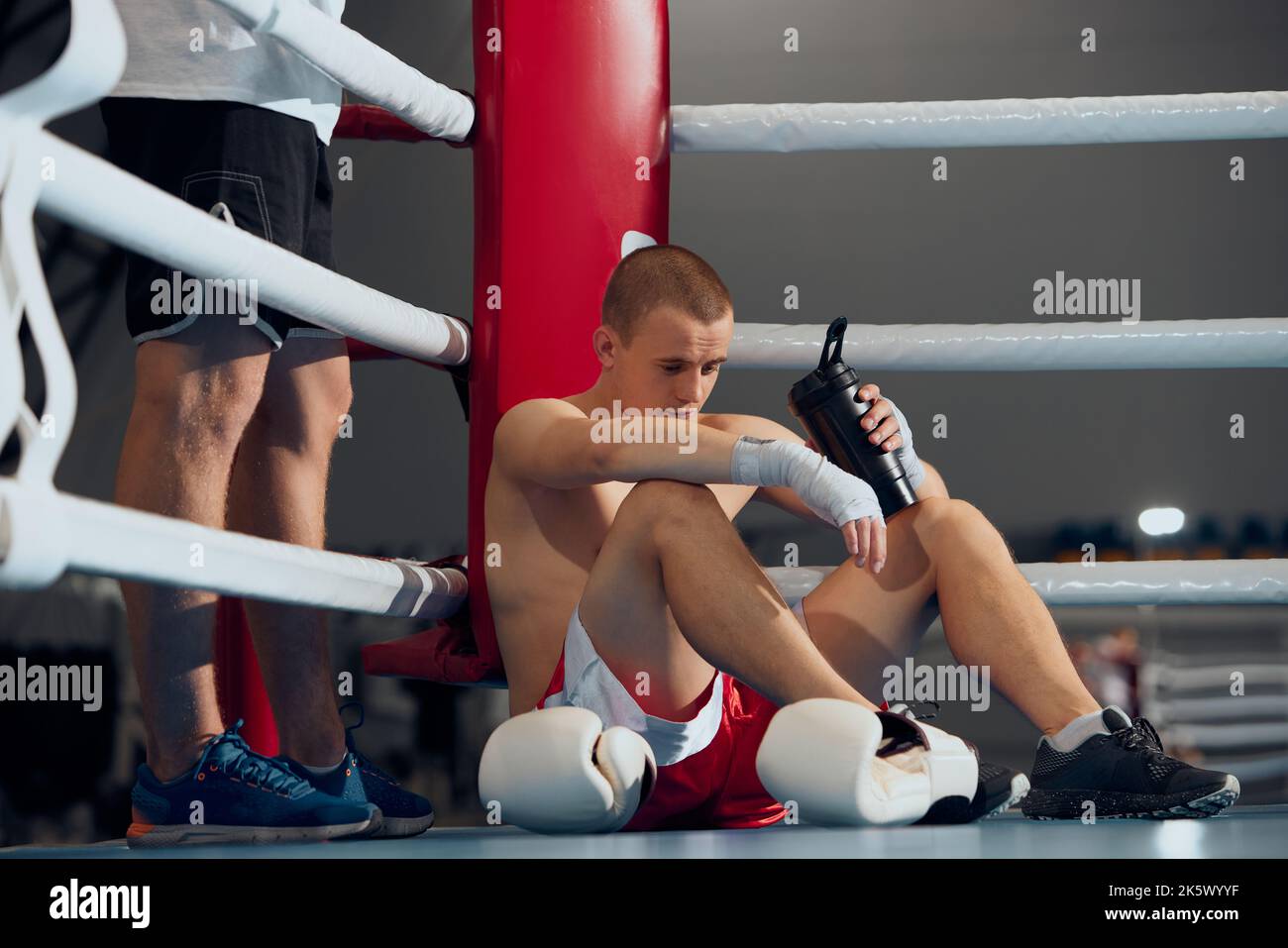 Pre-fight consultation. Young boxer training with personal coach ...