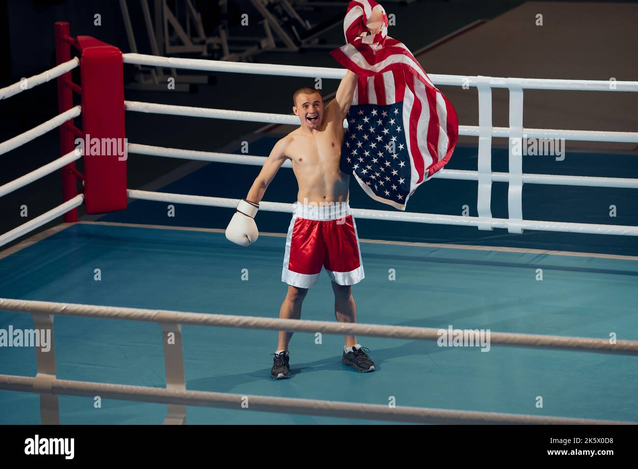 Winner emotions. Male boxer with american flag on his shoulders ...