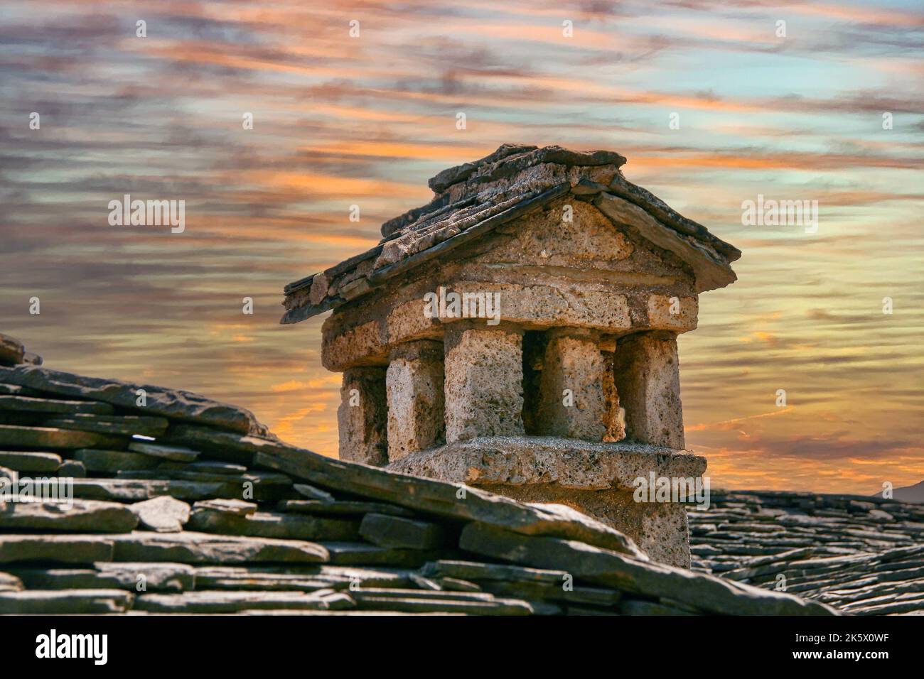 Typical traditional greek, made out local stone chimney and roof on ...