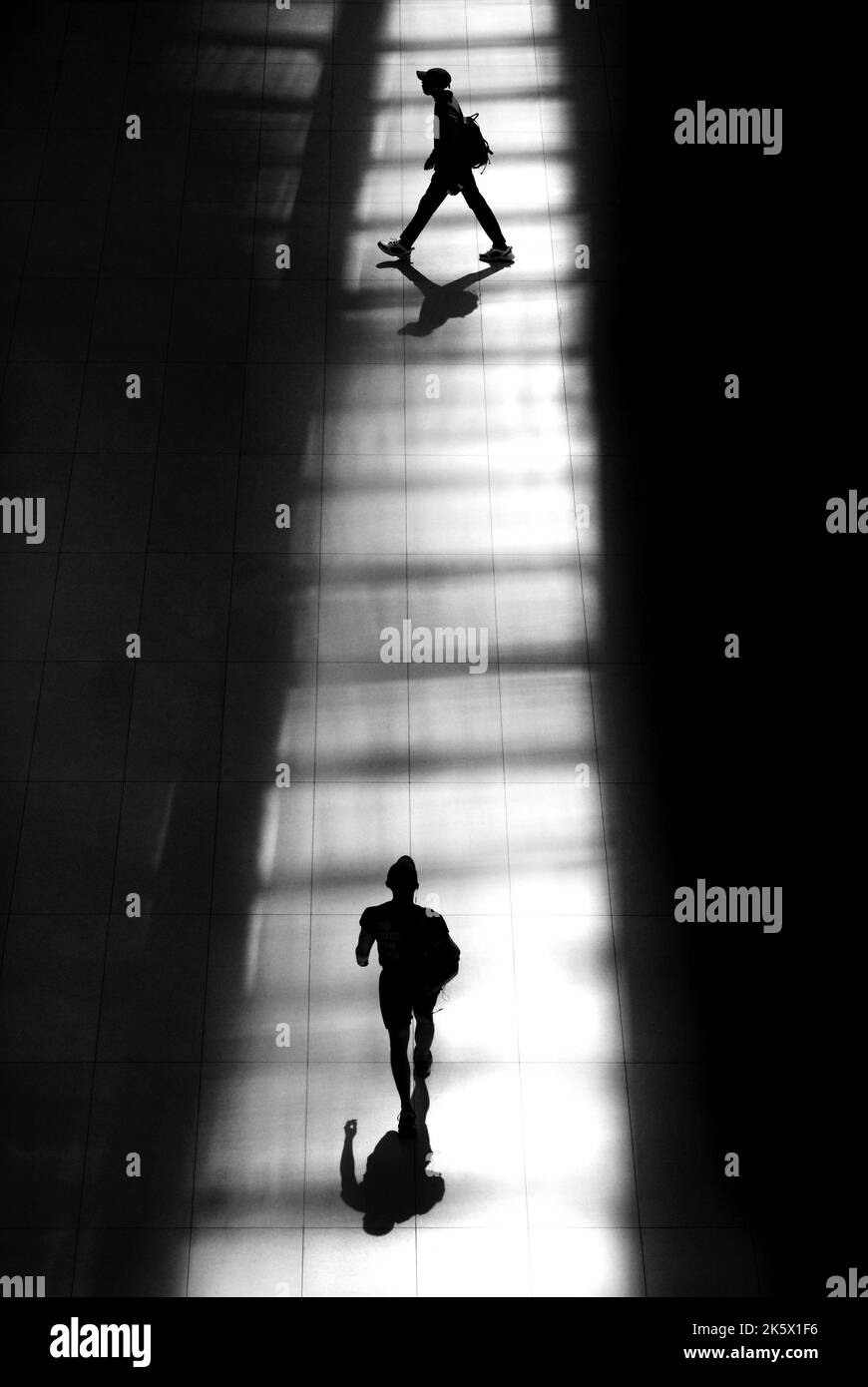 Silhouettes of people with shadows crossing the floor of Oculus ... Silhouettes of people with shadows crossing the floor of Oculus ...