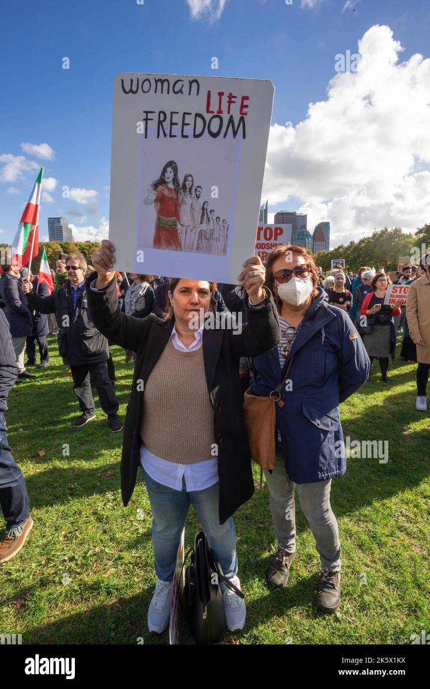 A protester holds a placard that reads 'woman life freedom' during the ...