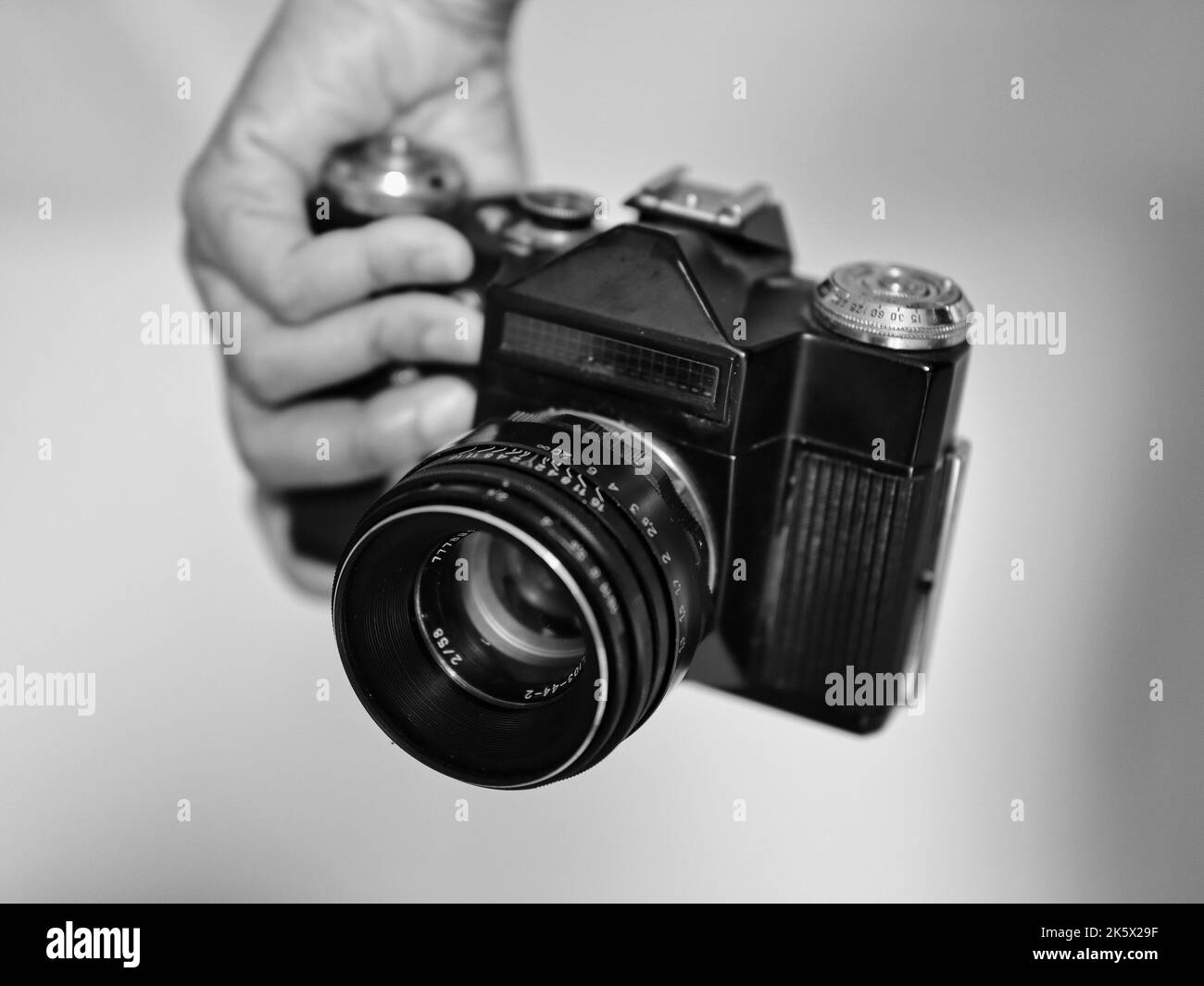Black Vintage camera held by a women's hand. Retro style Stock Photo ...
