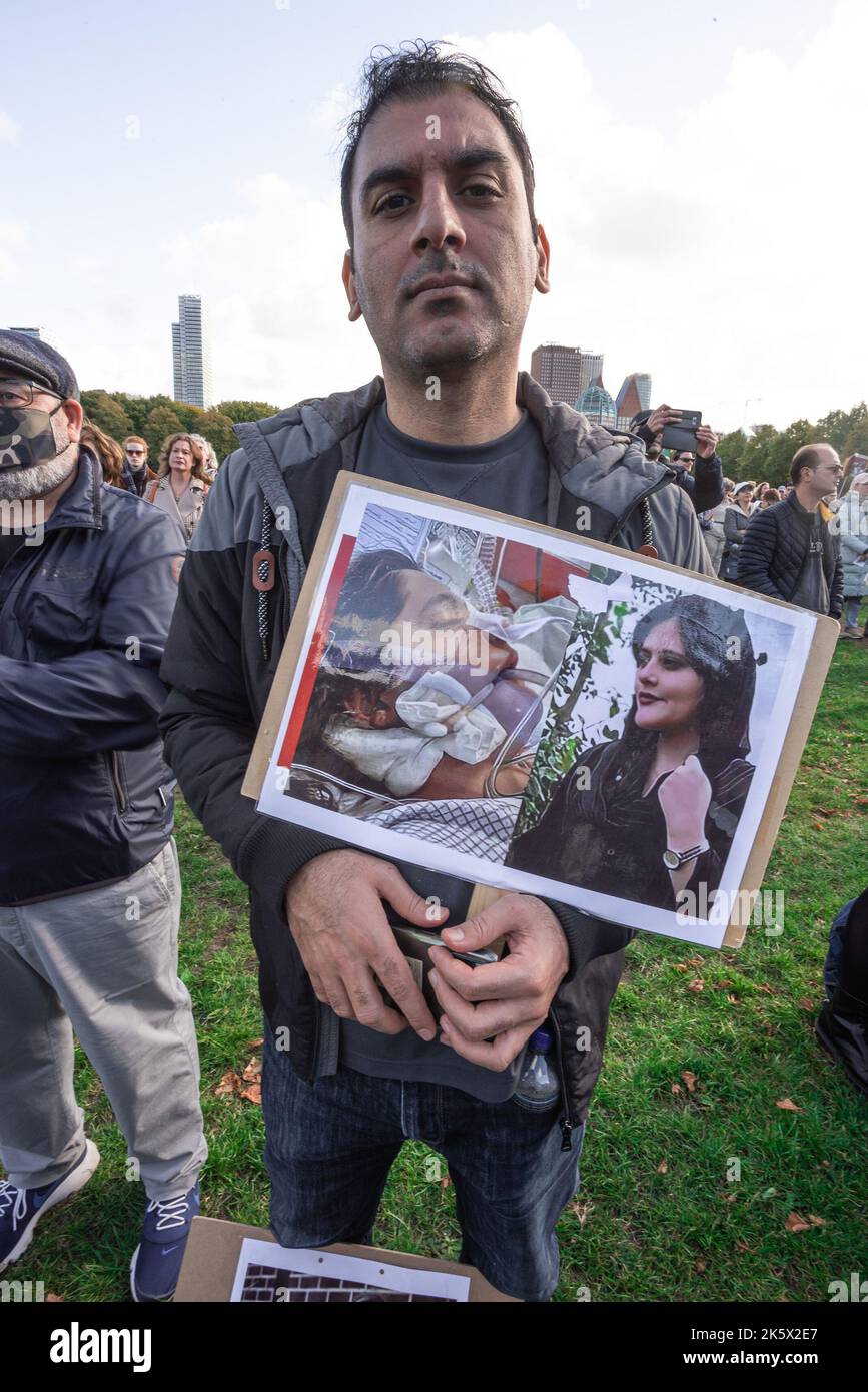 A protester holds photos of Mahsa Amin during the demonstration on the ...