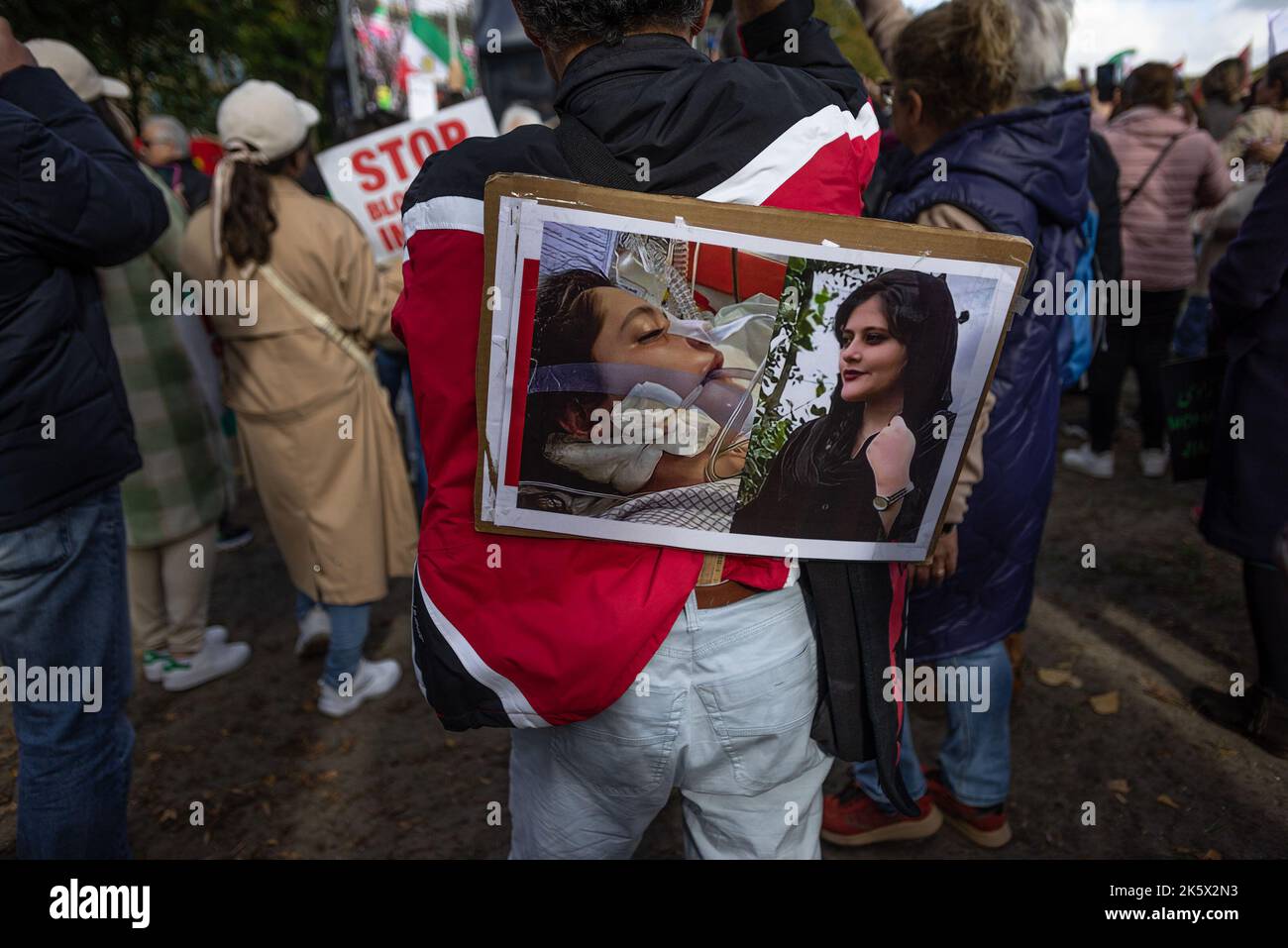 A protester carries a poster on his back of Mahsa Amin during the ...