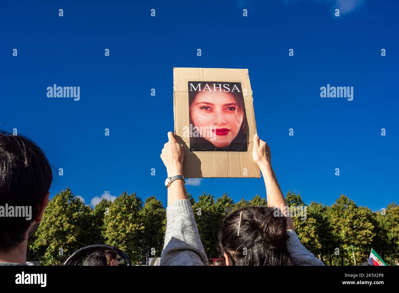 A protester holds a picture of Mahsa Amin during the demonstration on ...
