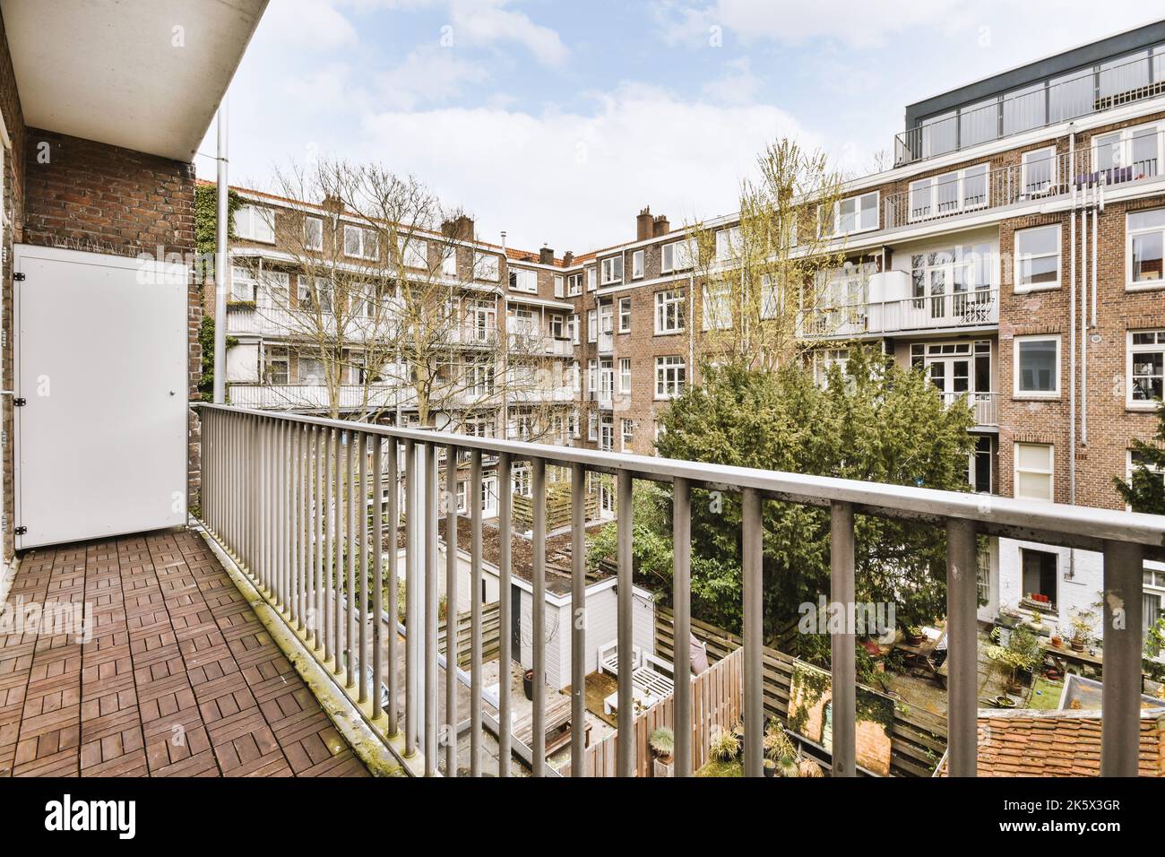 Narrow brick balcony with metal railings and door Stock Photo - Alamy