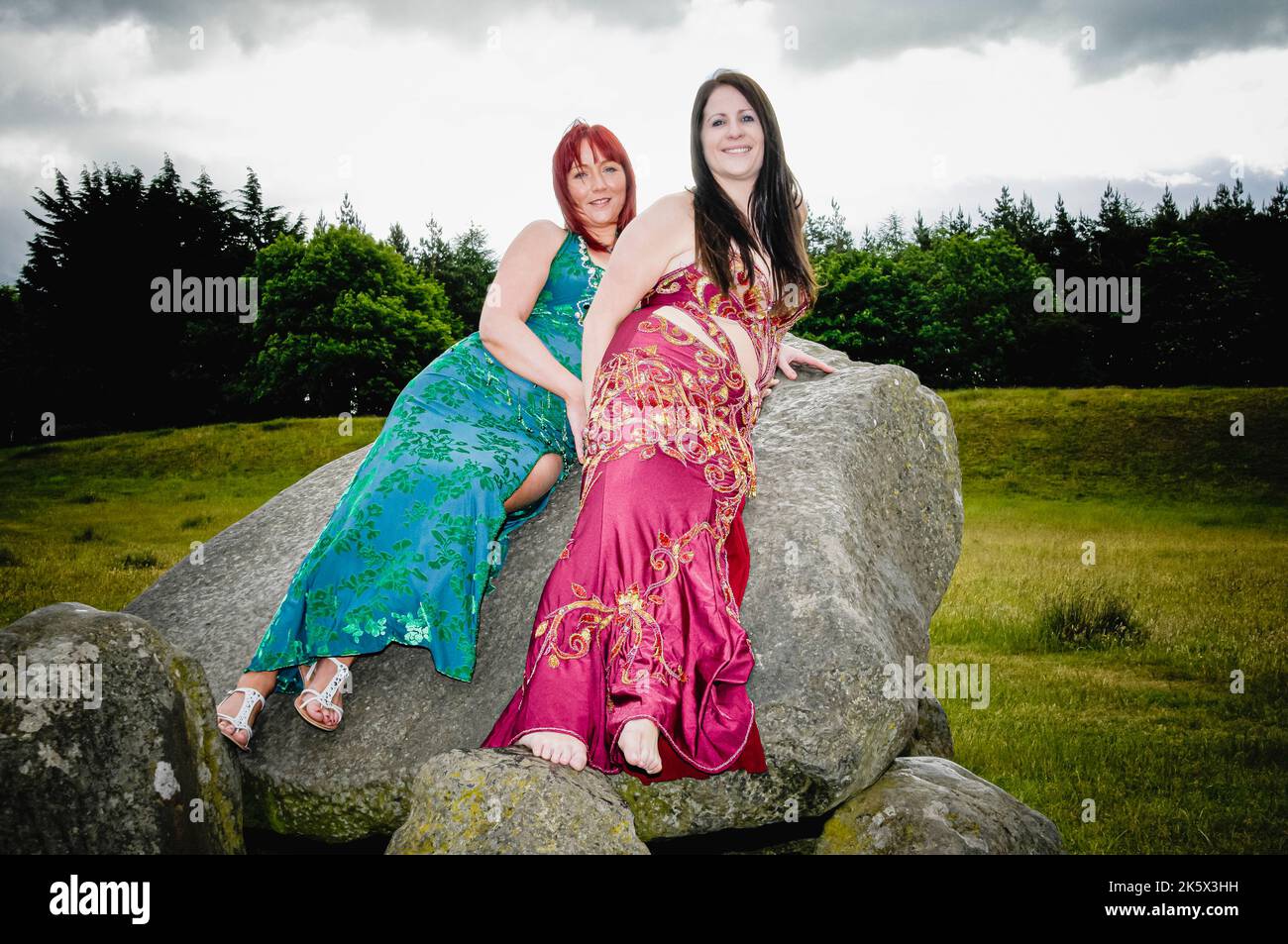 Two belly dancers wearing dress costume pose at the Giant's Ring stone ...