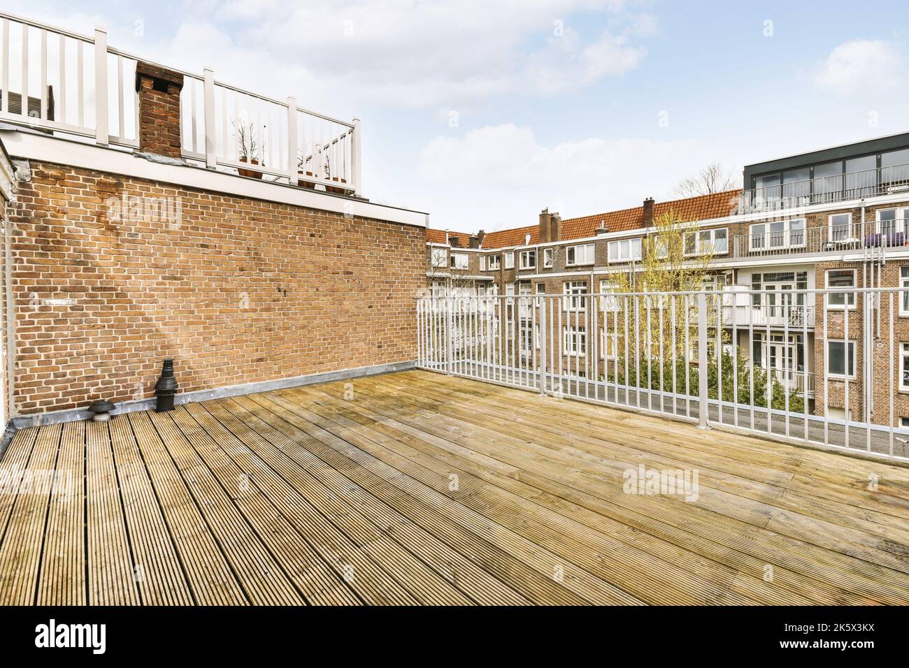 Bright brick balcony with metal railings and door Stock Photo - Alamy