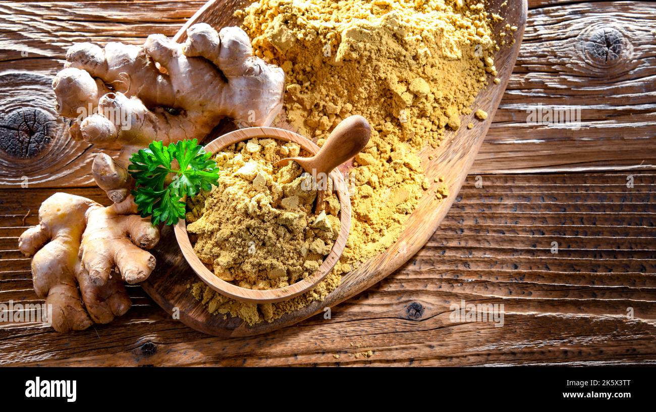 A bowl with ground ginger and its fresh rhizome Stock Photo - Alamy