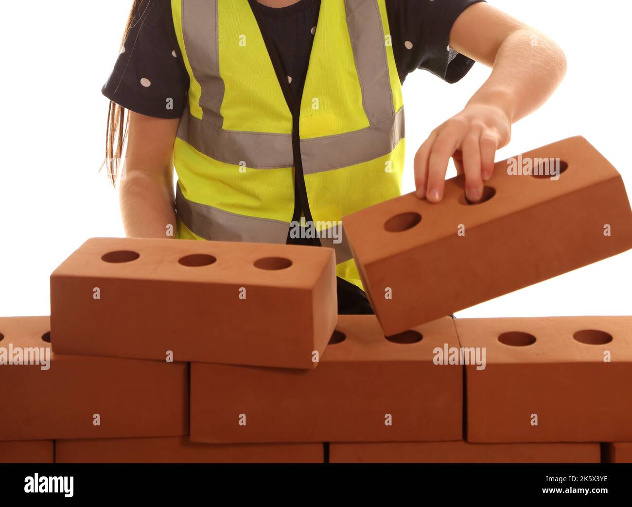 Child role playing as a brick layer in a studio Stock Photo - Alamy