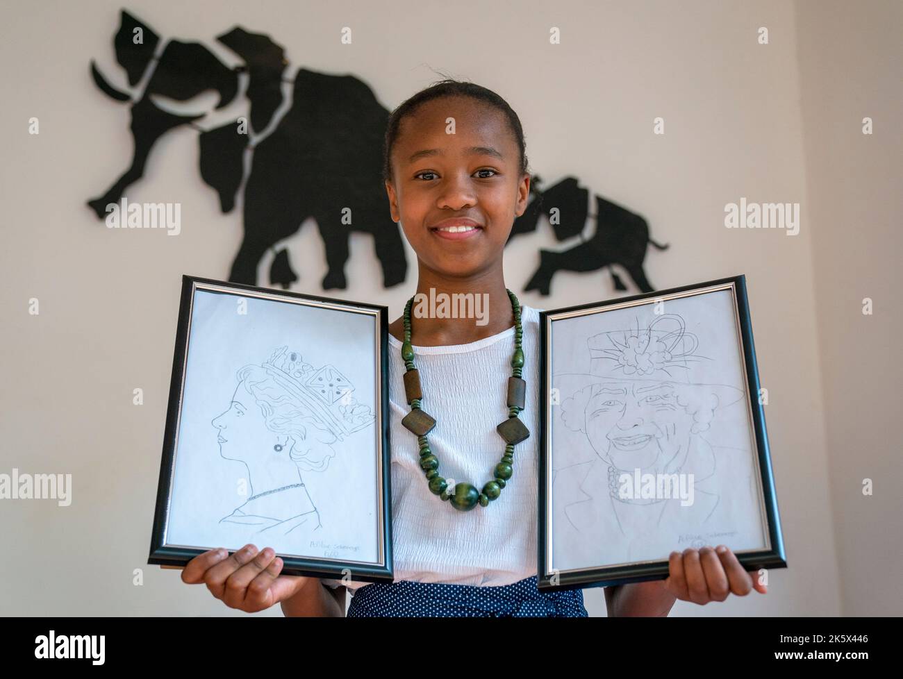 Afilwe Sebonego, aged 11, with drawings she created of Queen Elizabeth ...