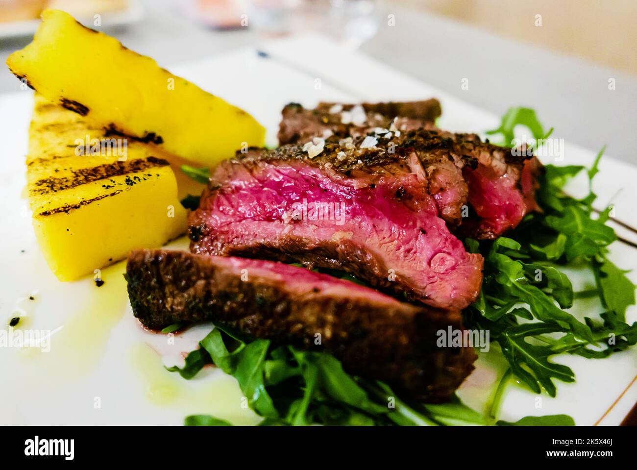 Rare beef on a plate with rocket and pancetta in a restaurant Stock ...