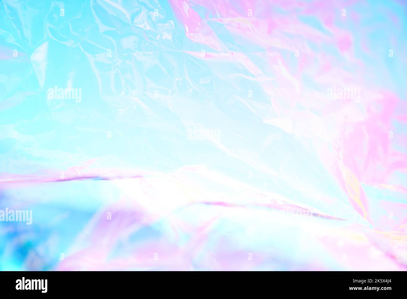 Holographic colorful plastic film in blue and pink tones. Transparent ...