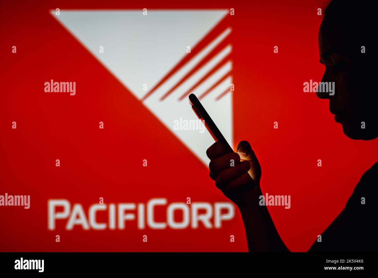 In this photo illustration, a woman's silhouette holds a smartphone ...